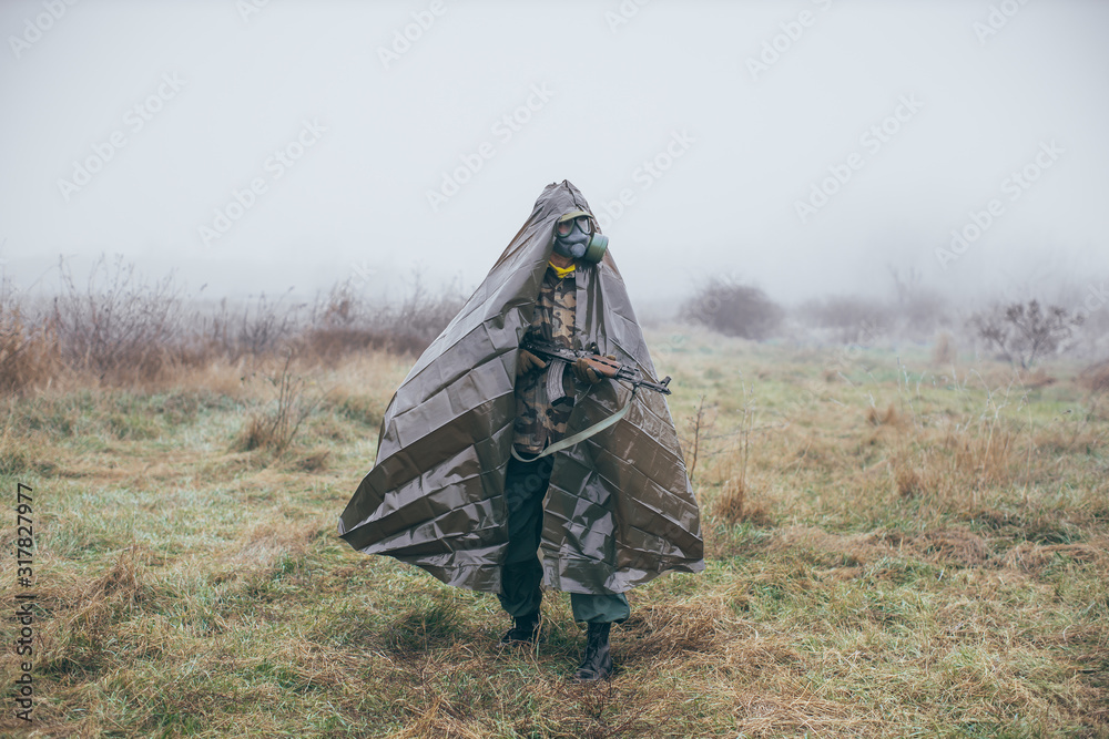 soldier with machine gun wearing gas mask and chemical weapons ...