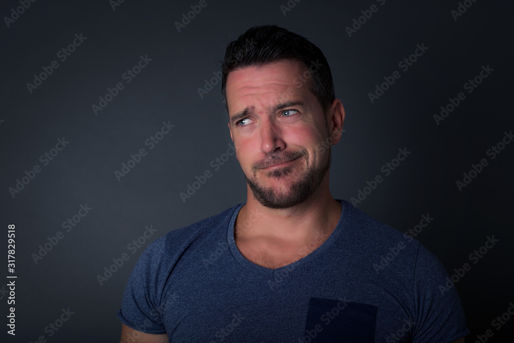 Photo of amazed puzzled young Caucasian male with ginger hair knot ...