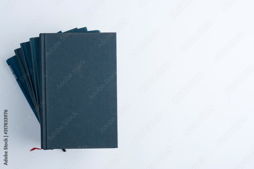 Classic blue book stack on the right side. top view, white background ...