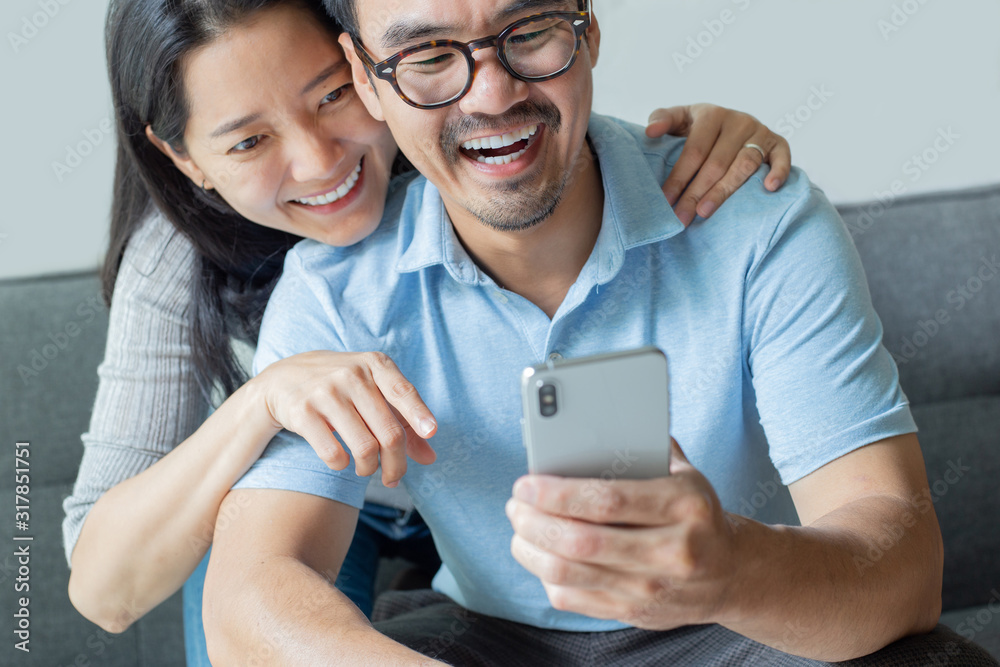 using cell phone couple asian lover happy enjoy sitting on sofa at home ...