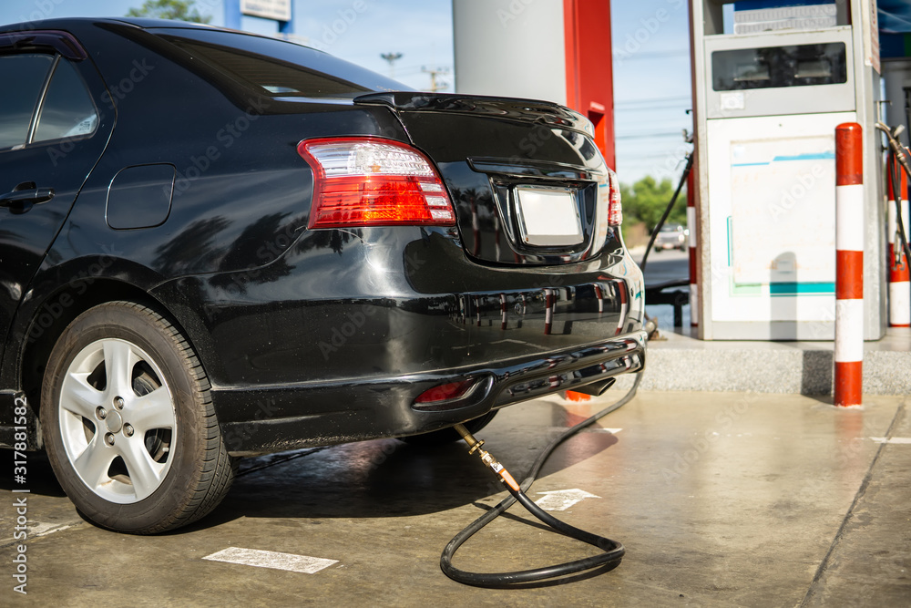 Refueling a black car AT Lpg Gas Filling Station Stock Photo | Adobe Stock