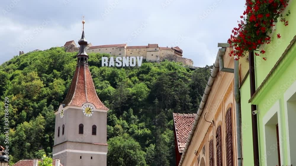 View of the the famous Rasnov city sign and Clock tower of the Saint ...
