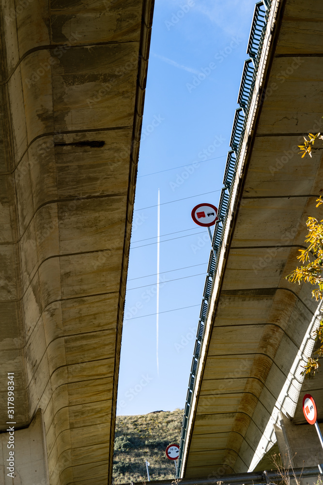 The white plane flies in the sky, the jet engine makes the white line ...