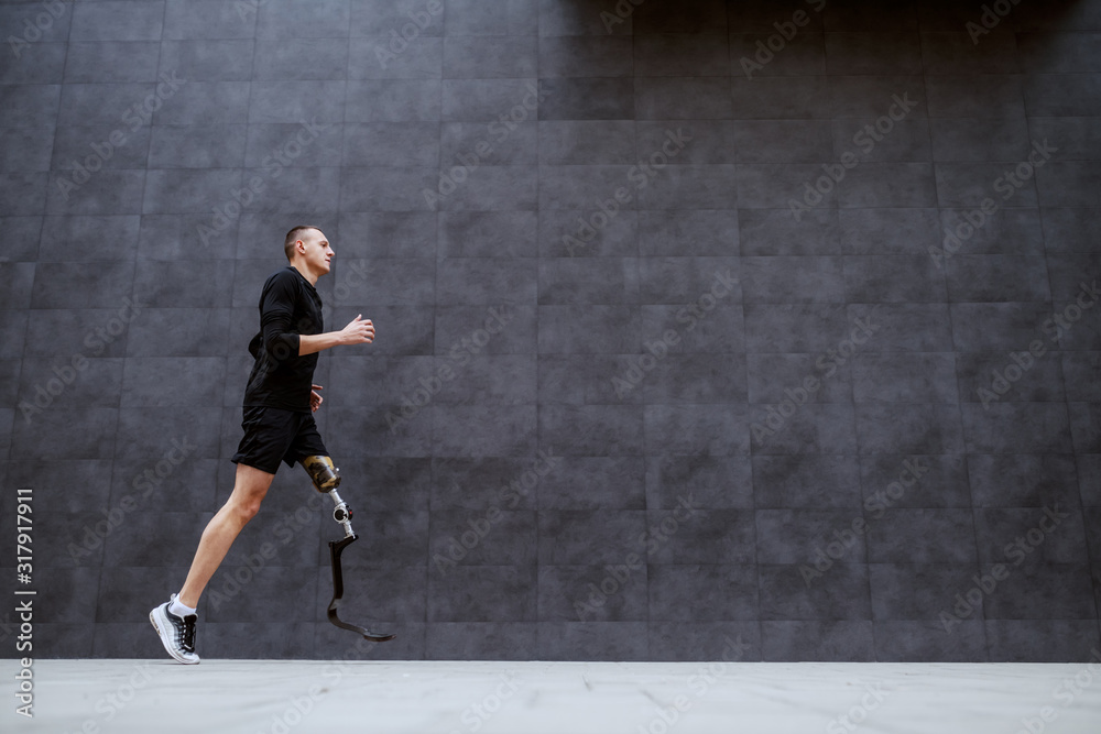 Side view of handsome fit caucasian sportsman with artificial leg ...