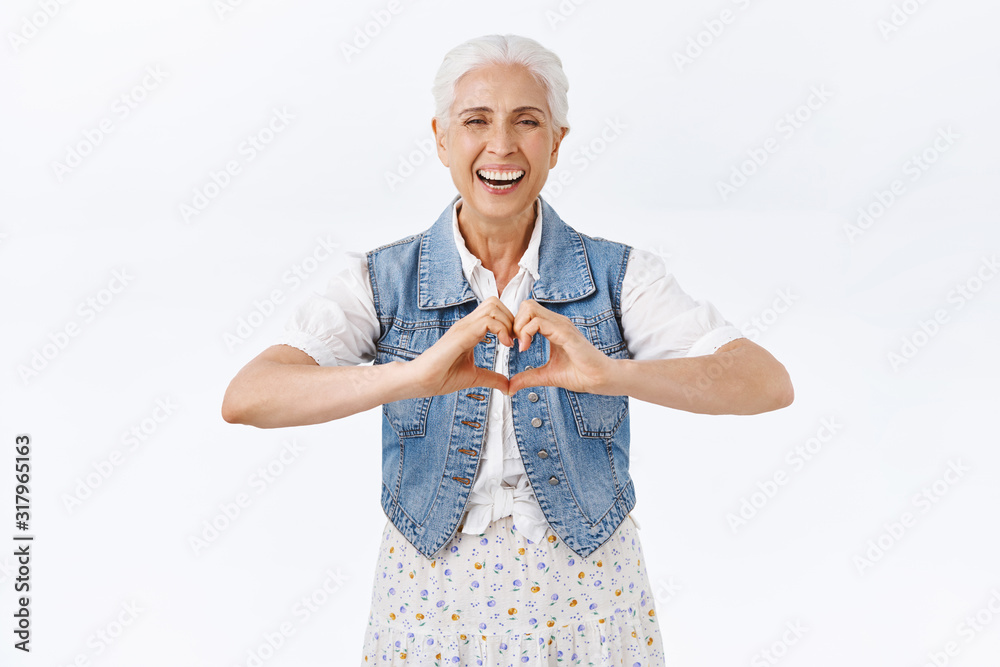 Modern, carefree charming old lady, senior woman showing heart sign and ...