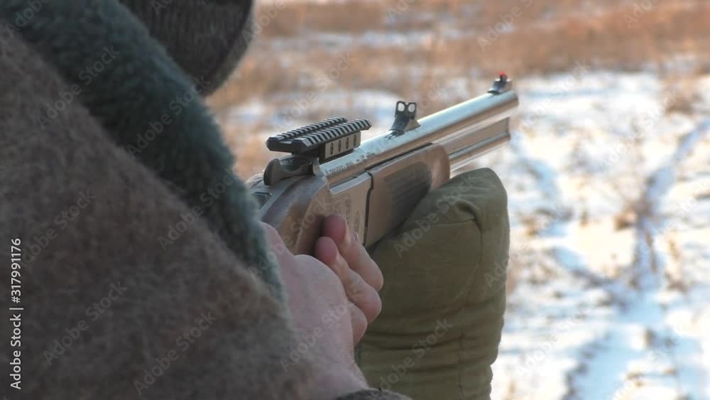 A sniper shoots from a Cheset rifle in winter. Shooting at a target ...