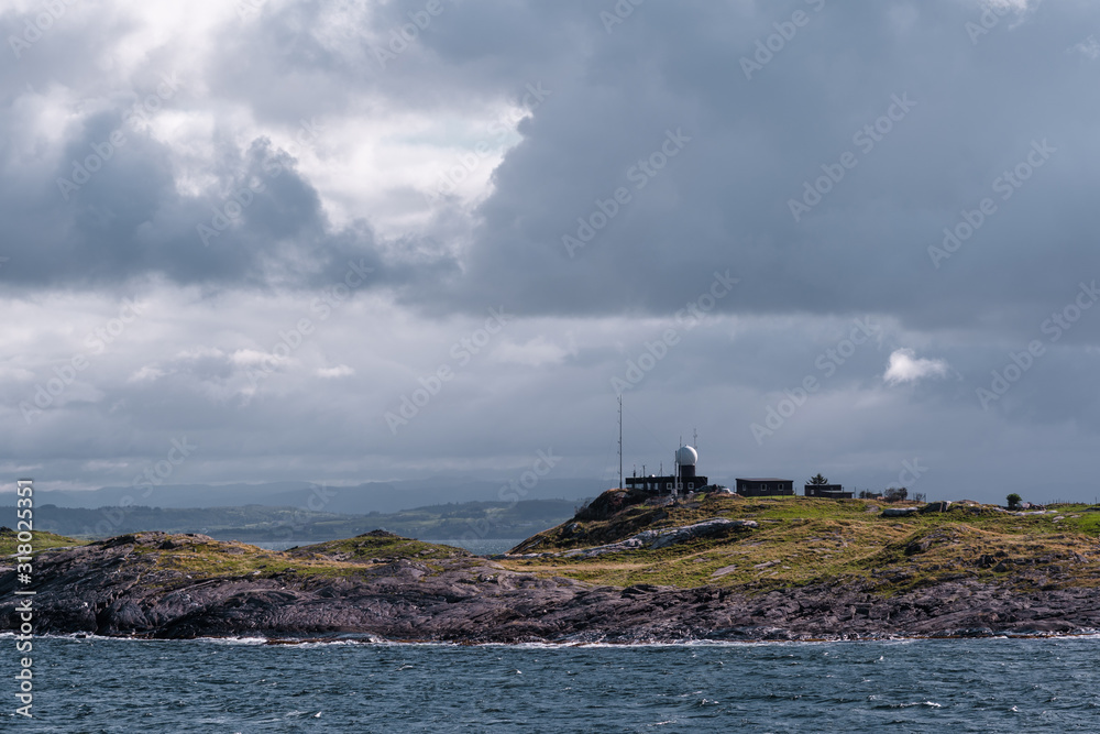 Harsh sea at Mortavika and the weather or radar station on the small ...