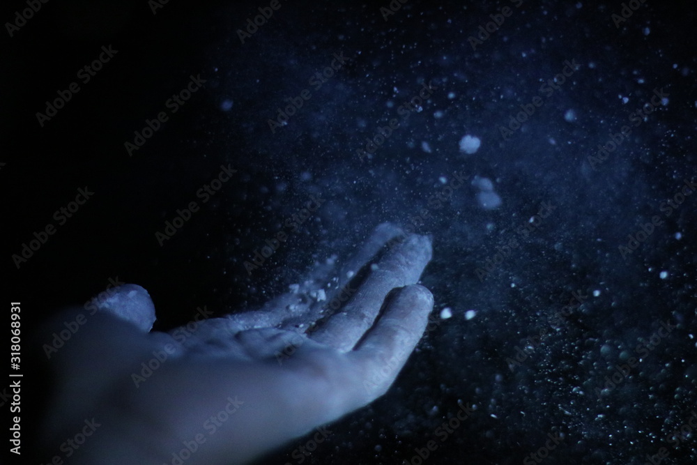 Cropped Image Of Hand Tossing Dust Against Black Background Stock Photo ...
