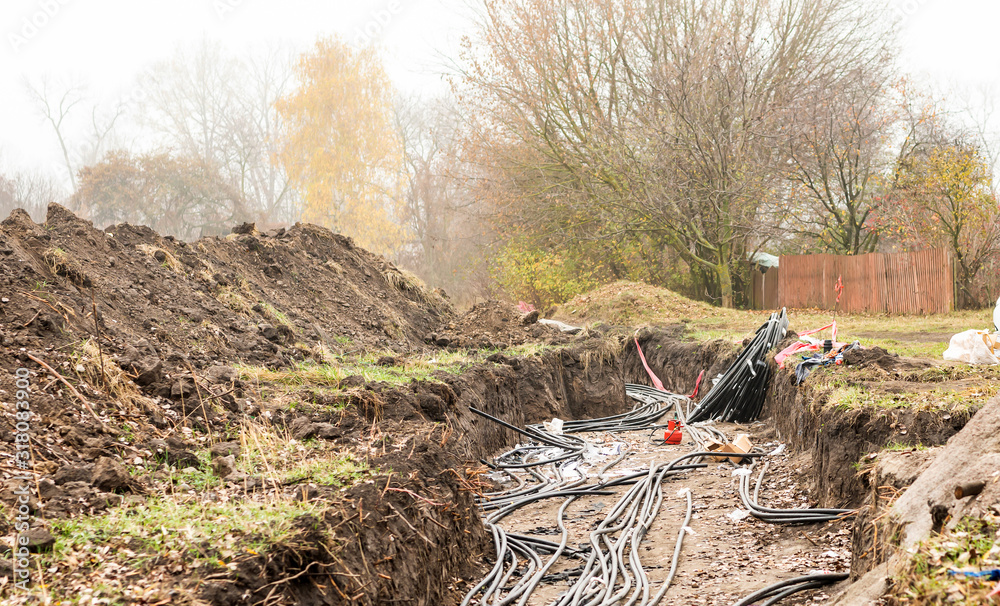 Laying of high-voltage cable lines in the earth trench Stock Photo ...