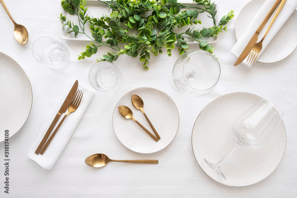 Tableware background in white gold tone.White plates, gold cutlery ...