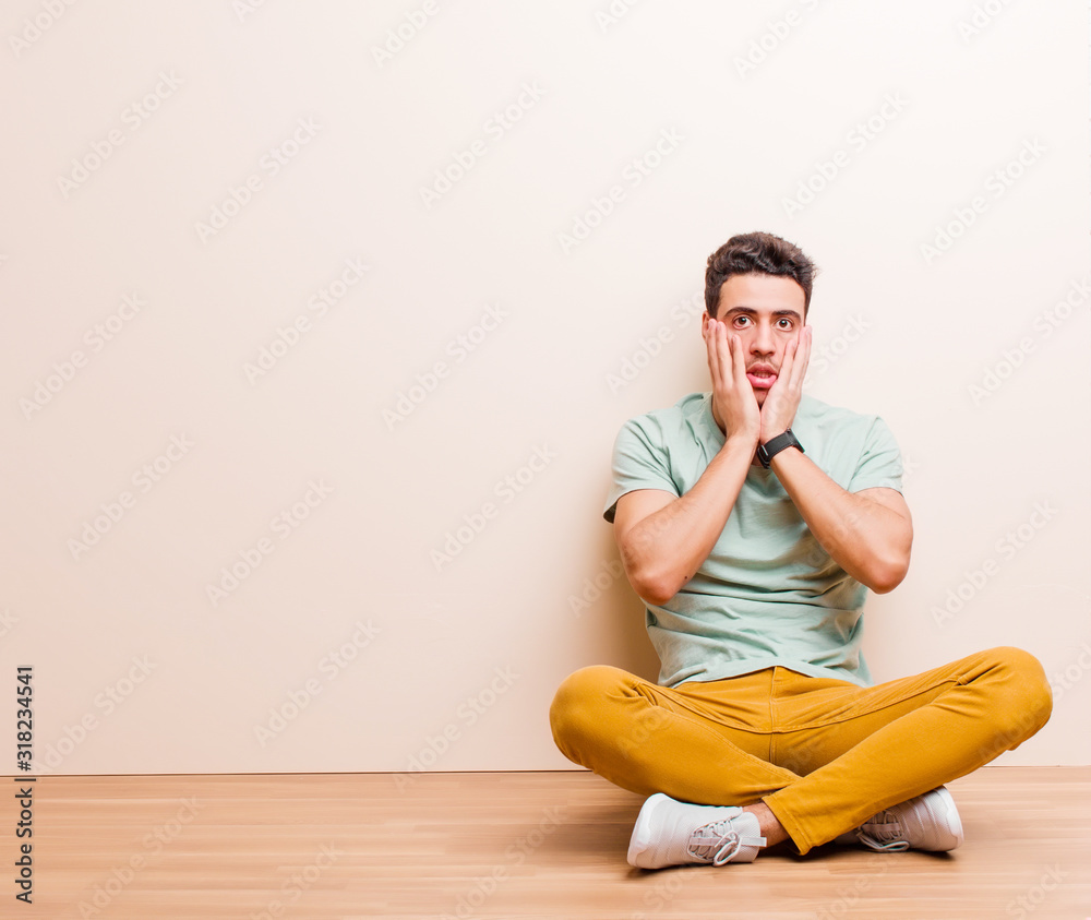 young arabian man feeling shocked and scared, looking terrified with ...