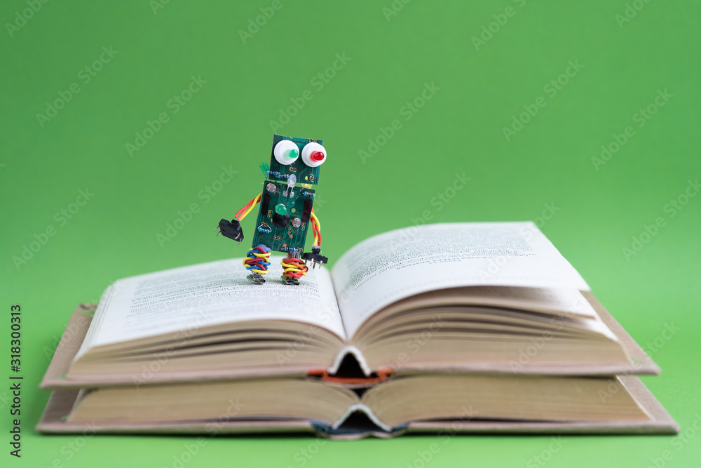 Hand made robot working on the arduino platform with books. Green ...