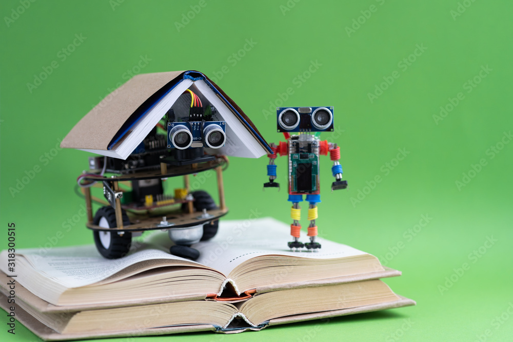 Hand made robot working on the arduino platform with books. Green ...