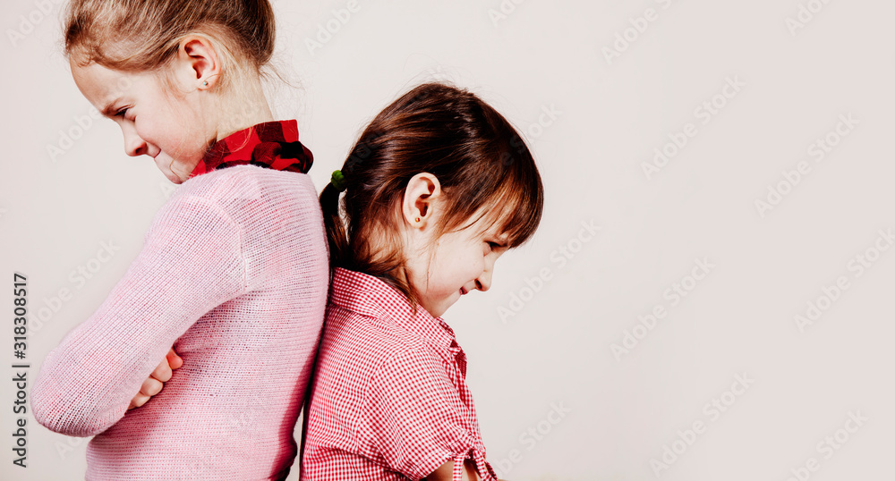 Quarrel and insult between two child girls or sisters. Sad young girls ...