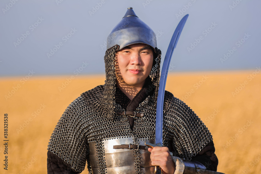 portrait of a medieval warrior in armor with a weapon in his hands ...