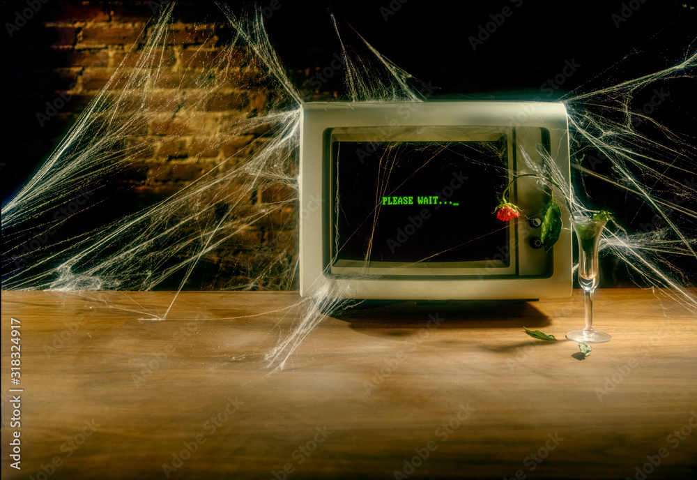 old computer on desk with cobwebs and "please wait" on screen Stock ...
