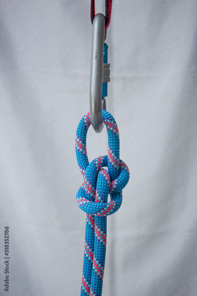 Bowline knot tied with a climbing rope to a pear shaped locking ...
