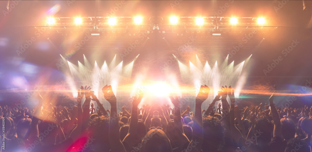 Front view of a concert stage with unrecognizable people silhouettes ...