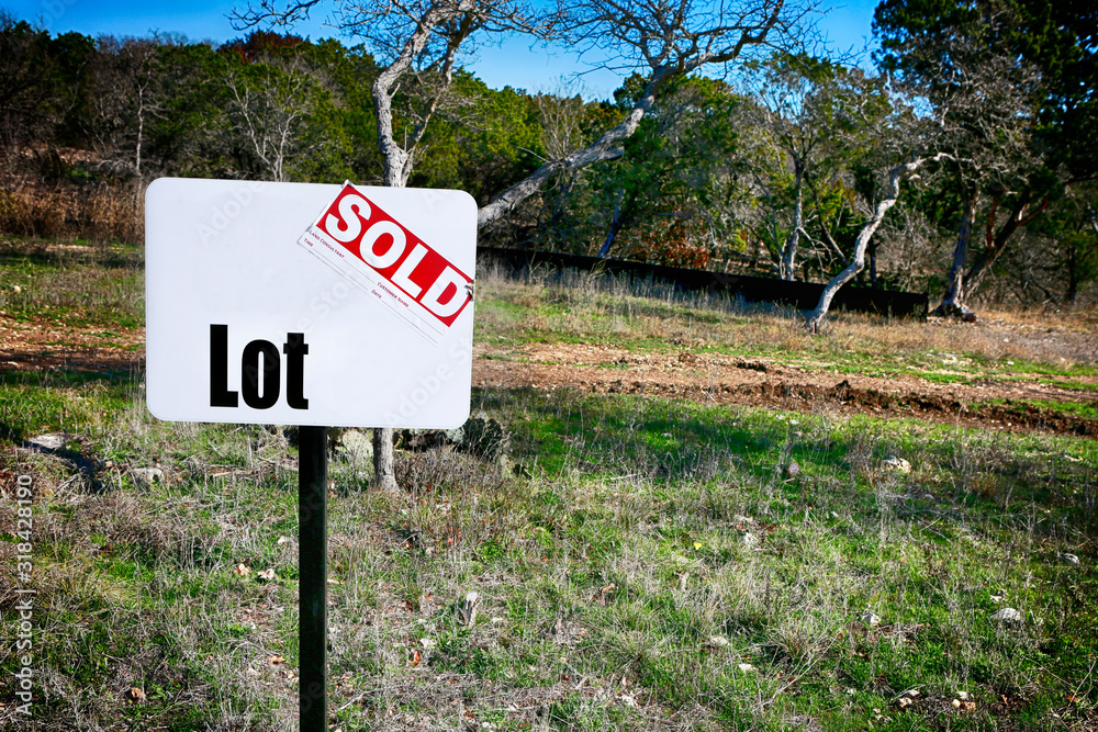 Land sale. Sign "LOT sold" with empty space for advertisement. Stock ...