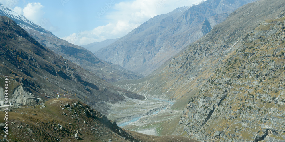 V-shaped Himalayas valley down which a river with a winding course ...