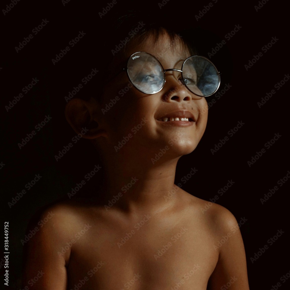 Smiling Shirtless Boy Wearing Eyeglasses Against Black Background Stock ...