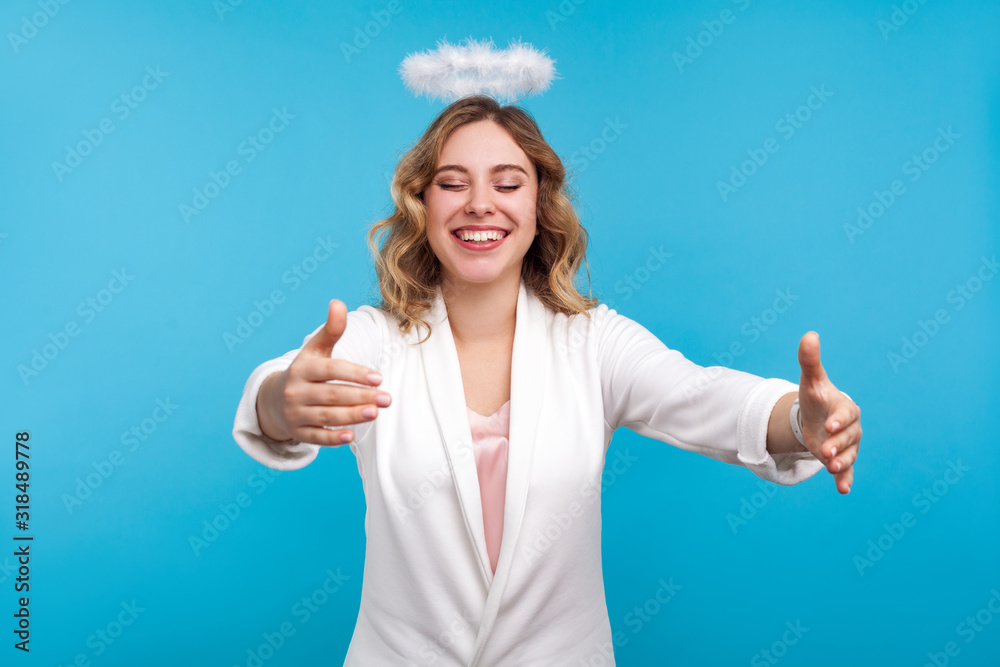 Portrait of friendly angelic woman with halo on her wavy hair and in ...