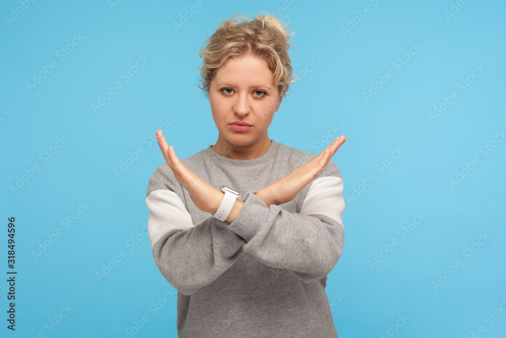 Finish, this is the end. Young woman in casual sweatshirt making x sign ...