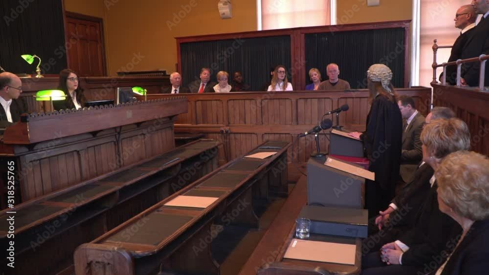 Female Barrister / Lawyer addressing the Jury in Court. She is wearing ...