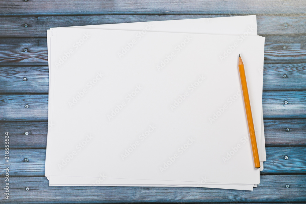 A4 white paper with pen on wooden background. Blank branding template ...