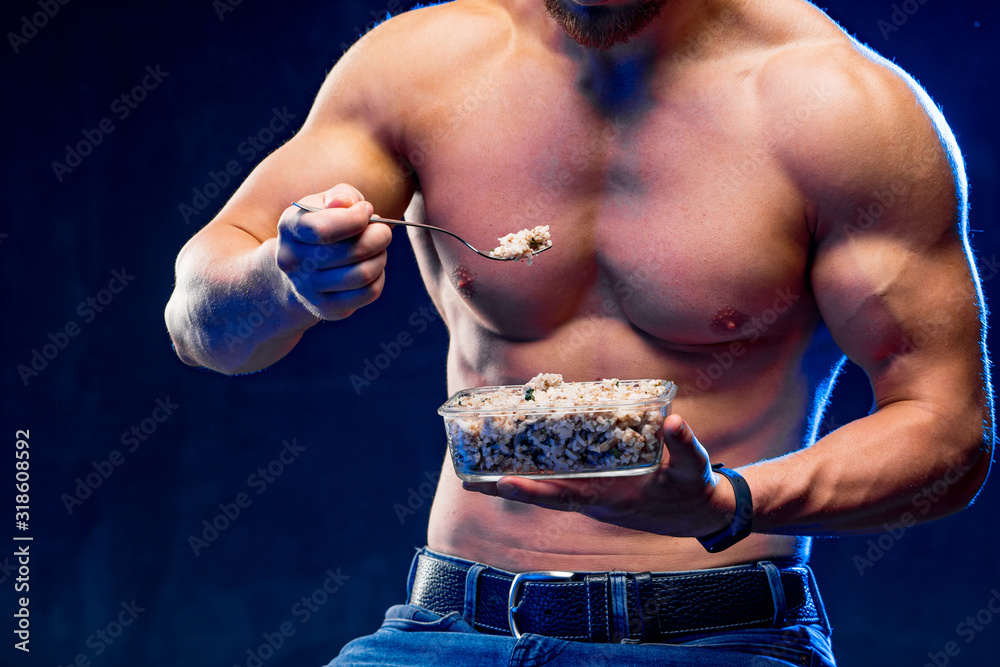 Muscular bodybuilder eating healthy white rice. Healthy lifestyle ...