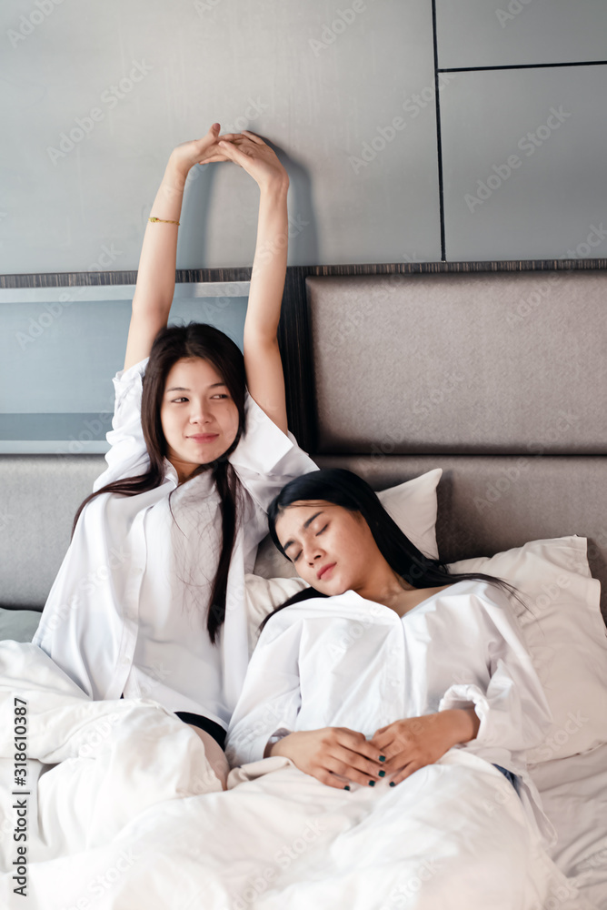 The beautiful woman laying down on bed, with her couple,sleeping ...