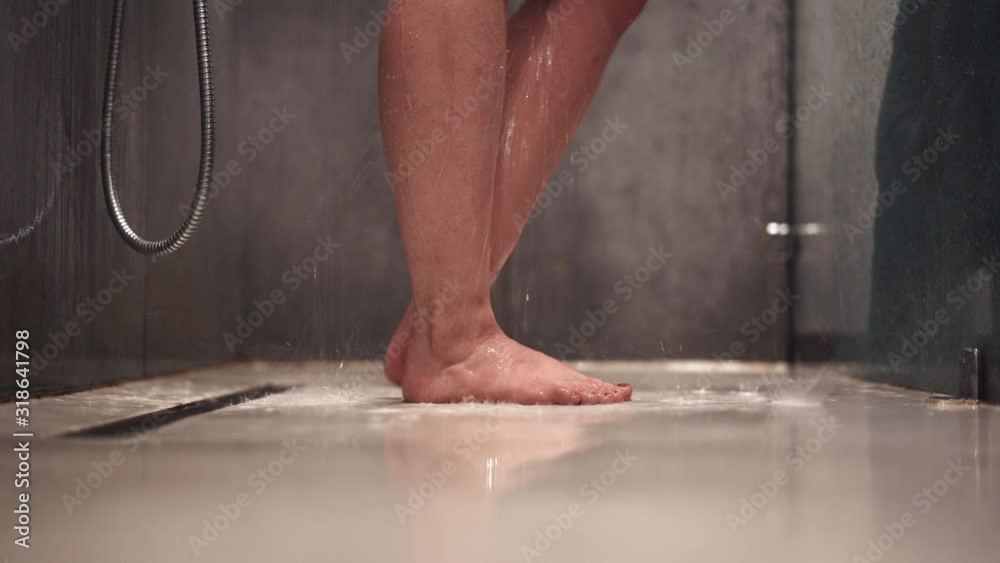 Woman 's legs close-up. Girl washing with gel in shower. Beauty care ...