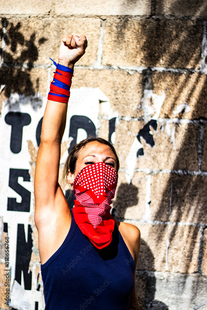 Beautiful strong young woman, activist and feminist put the fist up in ...
