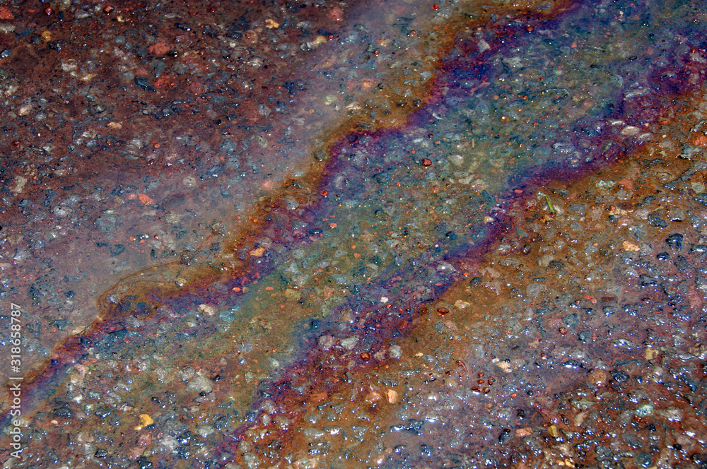 Oil sheen on pavement forms diagonal pattern Stock Photo | Adobe Stock