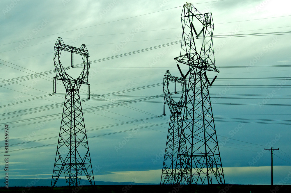 Silhouette of Transmission towers under cloudy skies on major ...