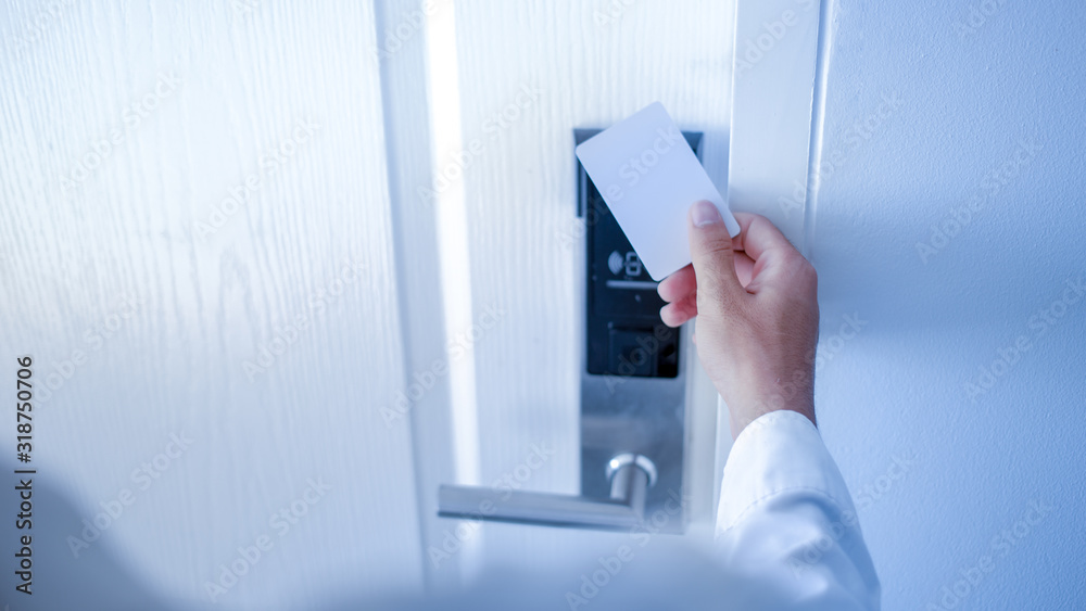 Hand holding key card using electronic card for access hotel room ...