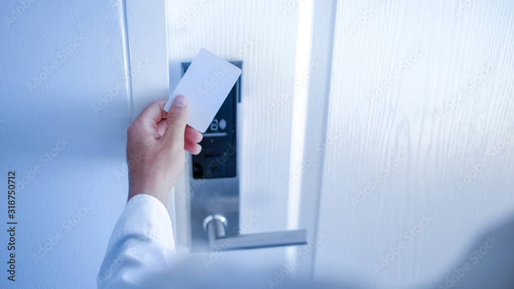 Hand holding key card using electronic card for access hotel room ...