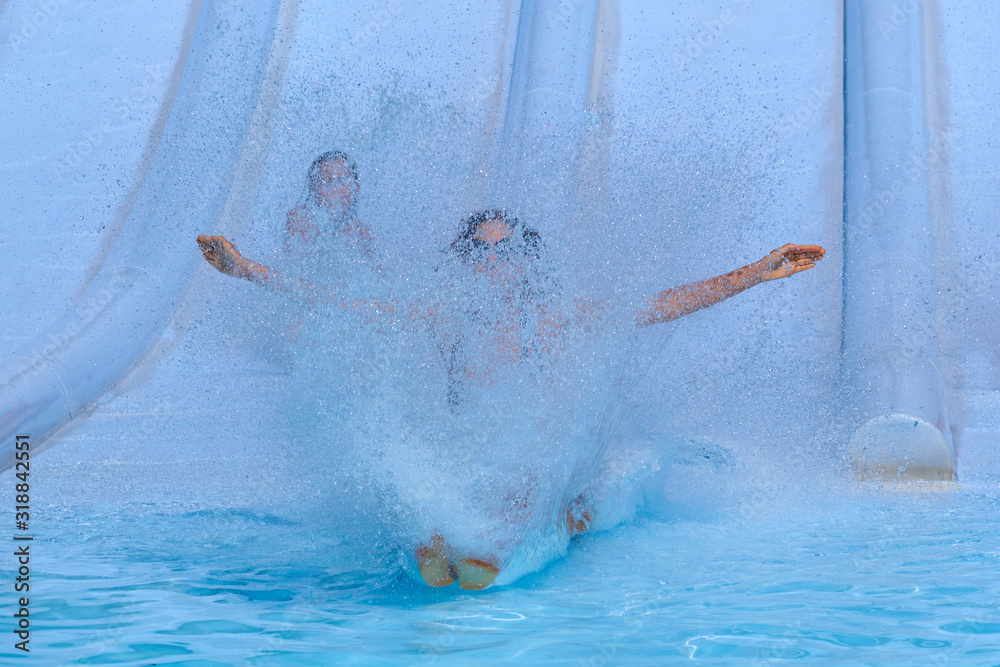 Water rides at the water park, girl riding down the water slide. Caneva ...
