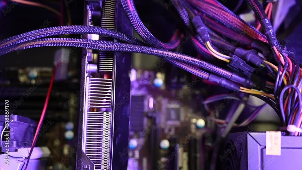 Checking power supply cord cables on a pc motherboard interior, purple ...