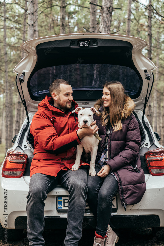 Happy family with dog in the forest. Active lifestyle. Happy look ...
