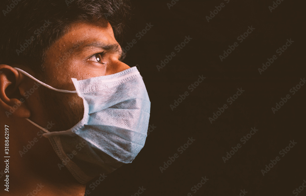 Young man wearing medical face mask to protect from spreading ...