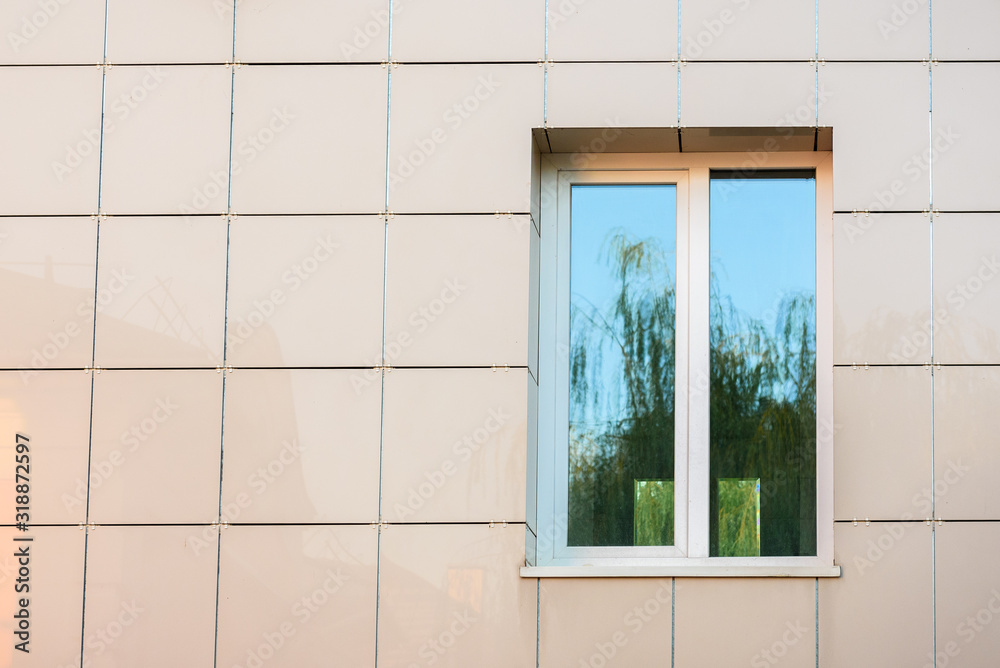 Installing big tile on a building facade. Stock Photo | Adobe Stock