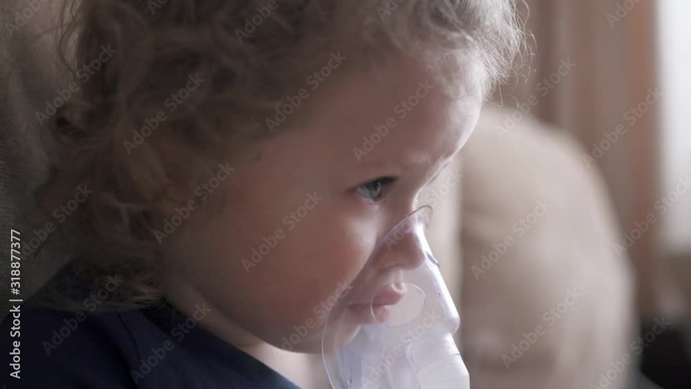 Nebulizer for inhalation, sick child breathes through nebulizer, baby ...