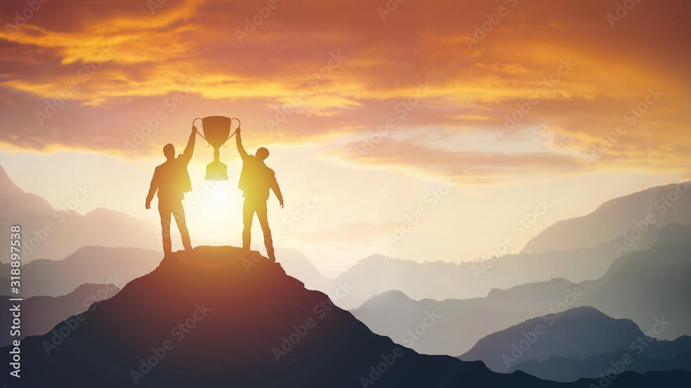 Silhouette of people team with trophy at sunset evening sky background ...