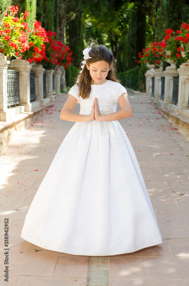 First Holy Communion, innocence girl praying in the park dressed in ...