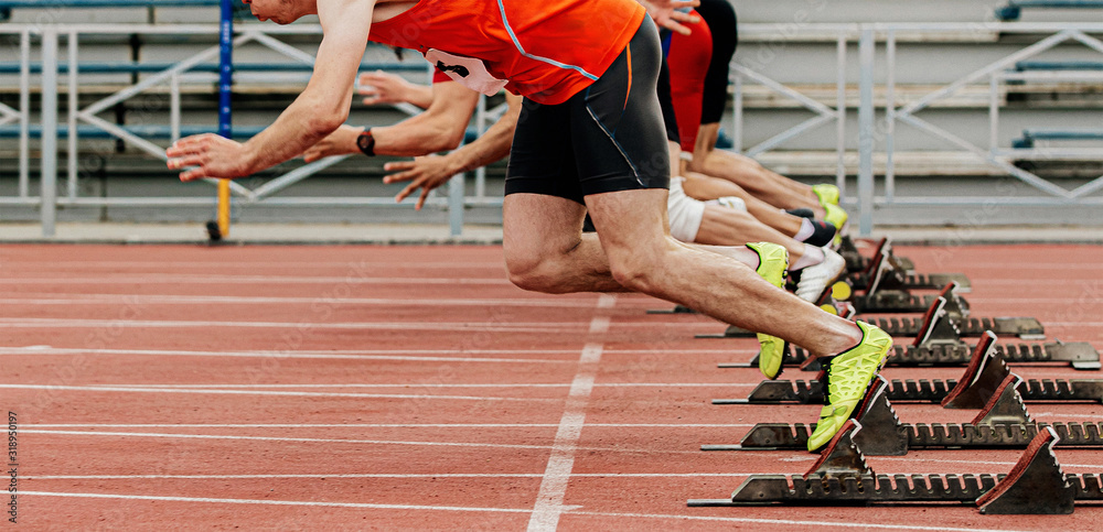start race male athletes runners running in starting blocks Stock Photo ...