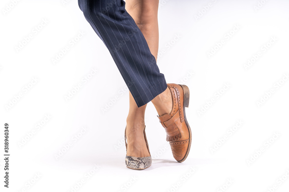 Foto de Woman legs with different shoes on each foot on white ...