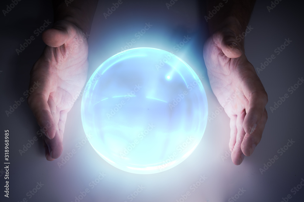 Magician or fortune teller is predicting future with crystal sphere ...