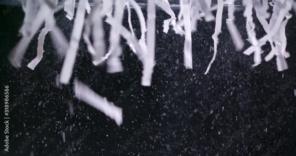 Tangled shredded paper being torn up and falling creating dusty mess ...