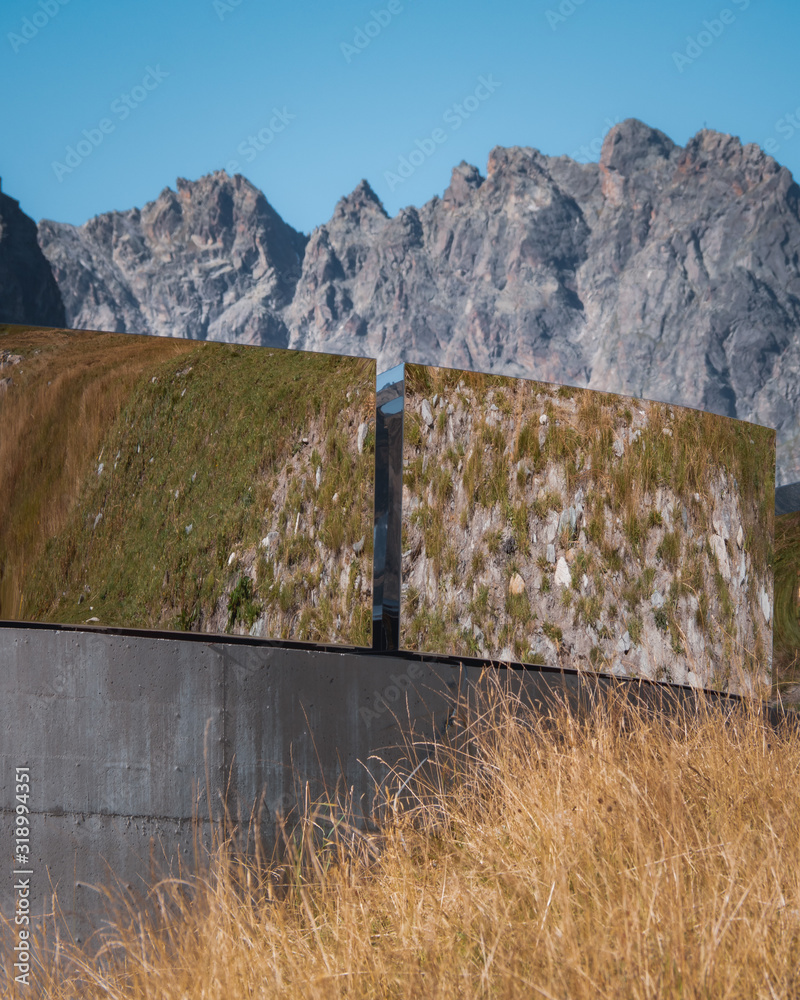 Mirrors on a mountain in Switzerland with mountain backdrop in sunny ...